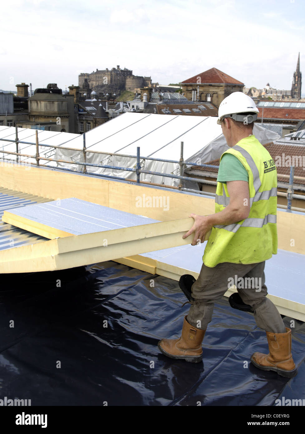 roofer working on roof lying insulation Stock Photo - Alamy