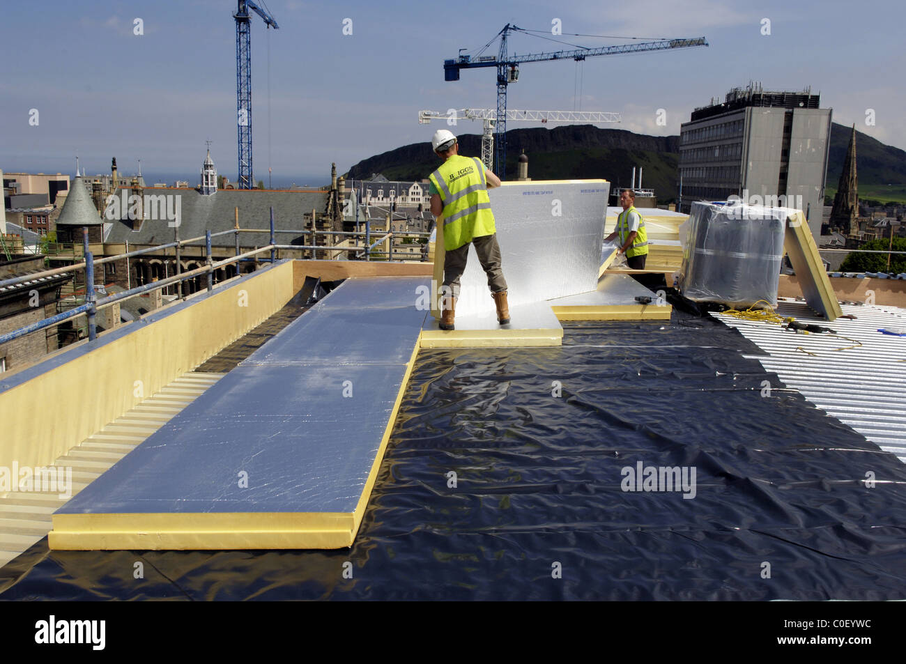 roofer working on roof lying insulation Stock Photo - Alamy