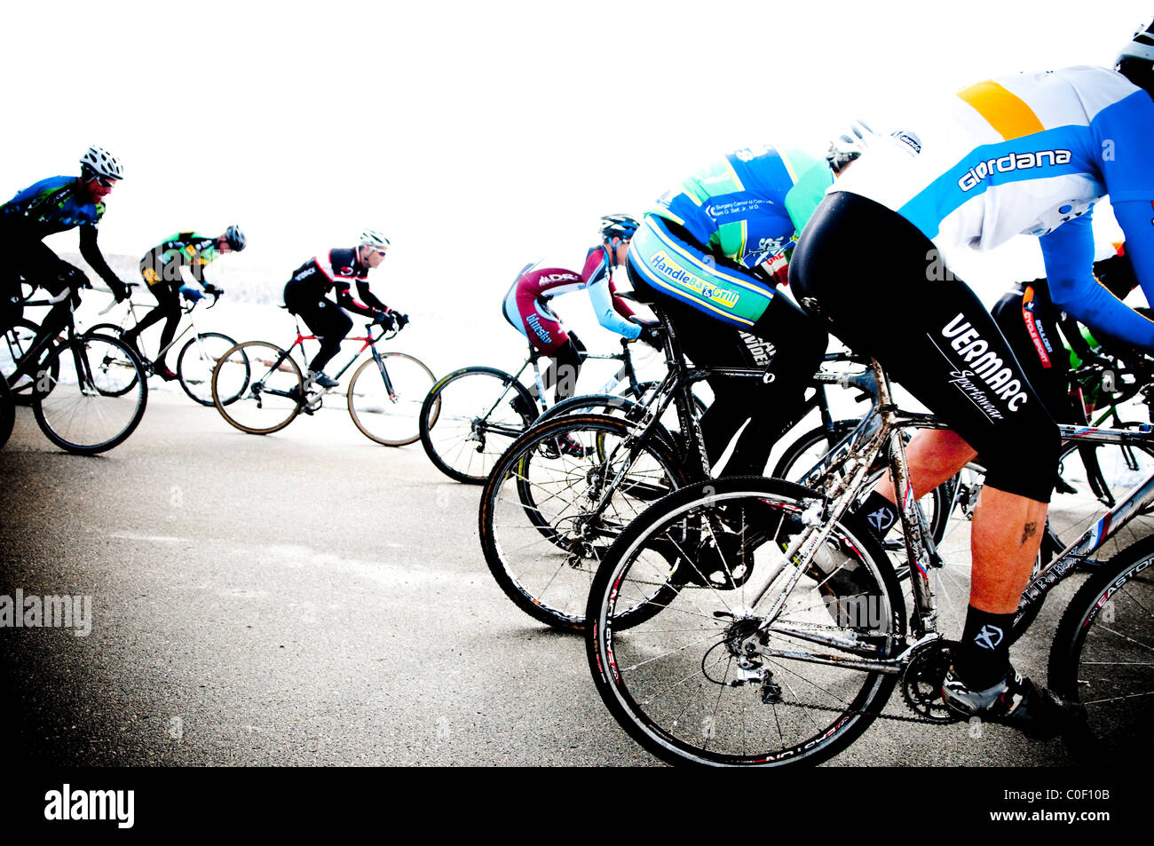 Cyclists race in the mud and snow at a Cyclocross race in Boulder, CO ...