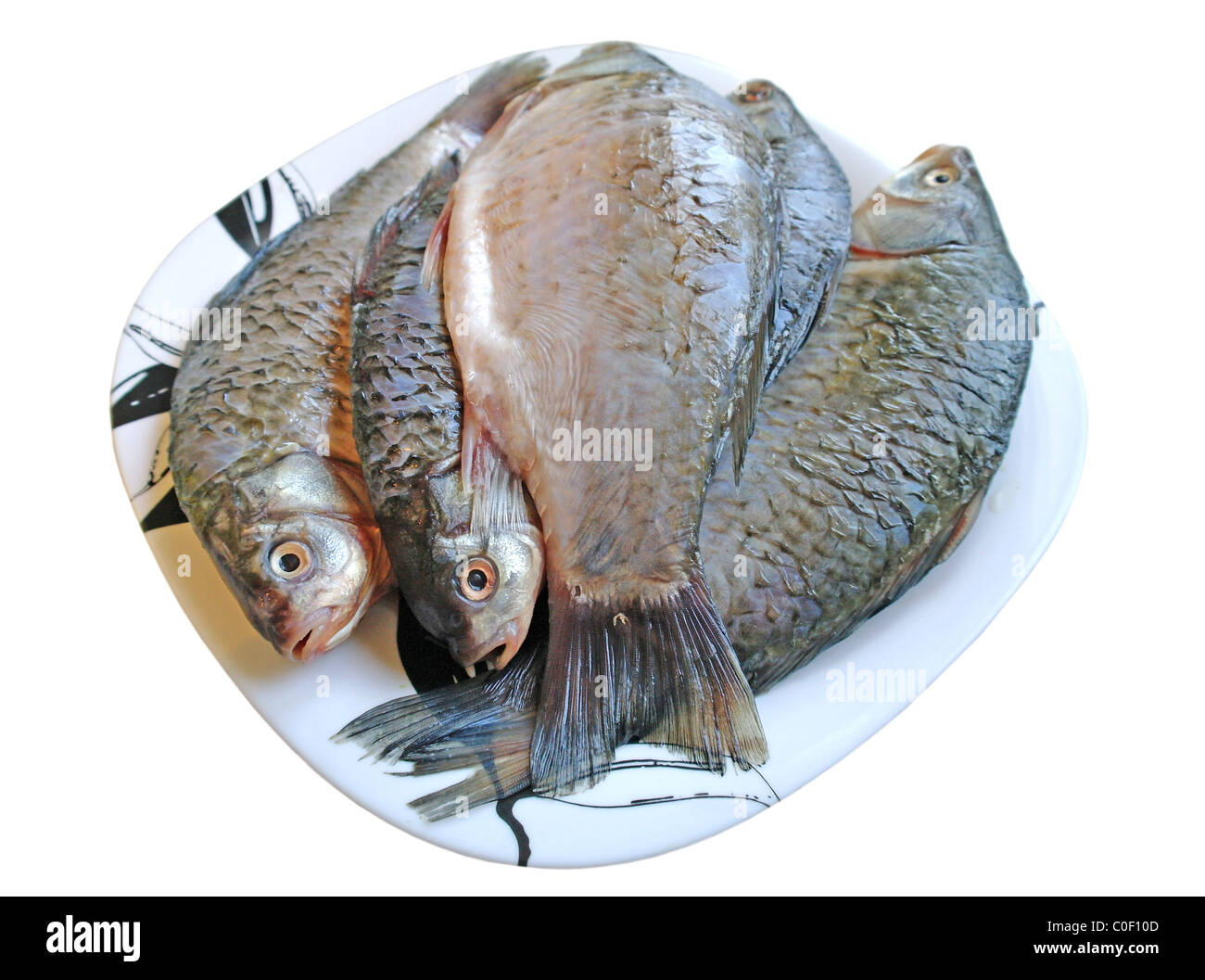 The cleared crude fish the Crucian on a plate, it is isolated, a white ...