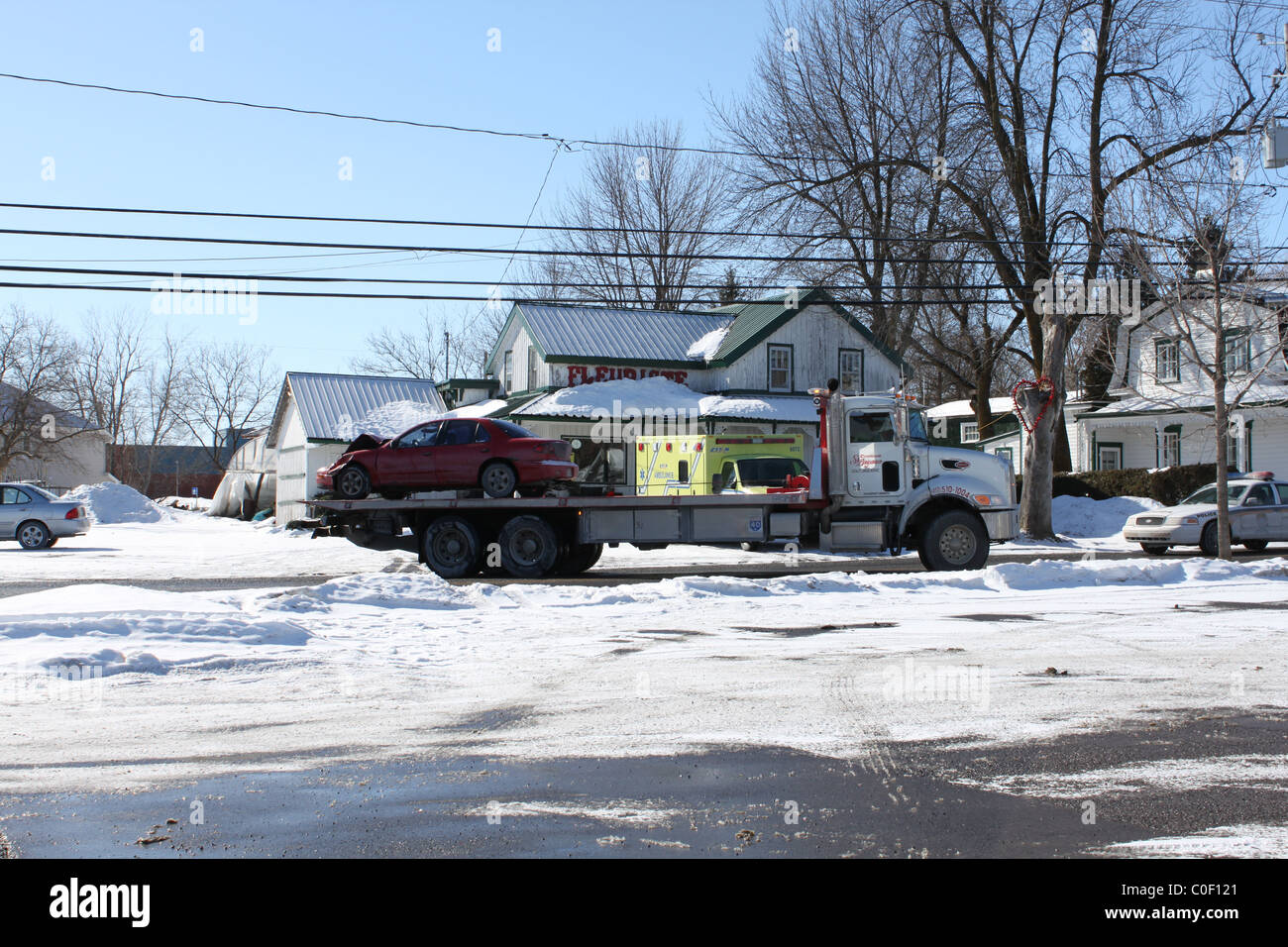Smashed red car on tow truck with ambulance and police cruiser Stock ...