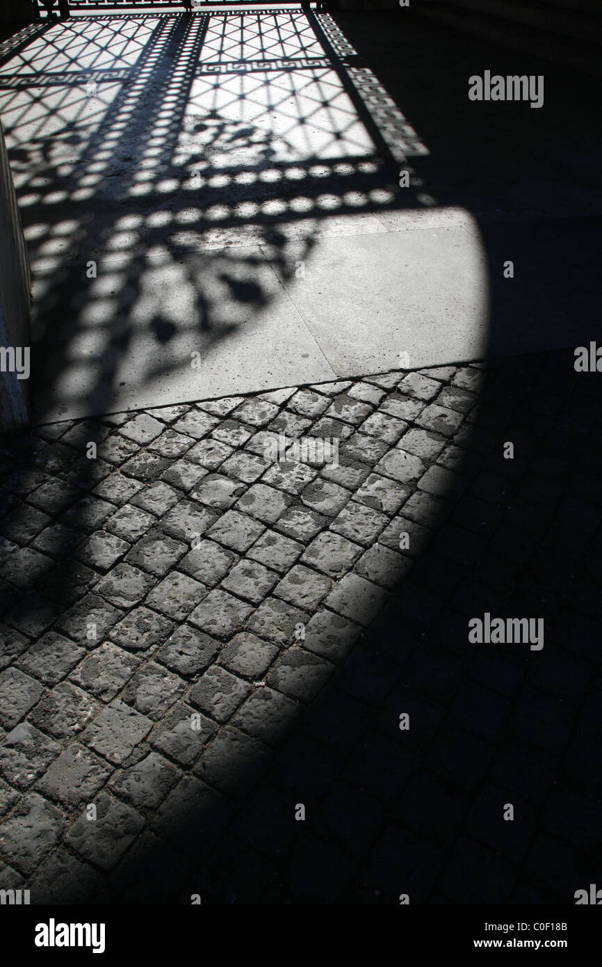 old gate shadow on street road Stock Photo - Alamy