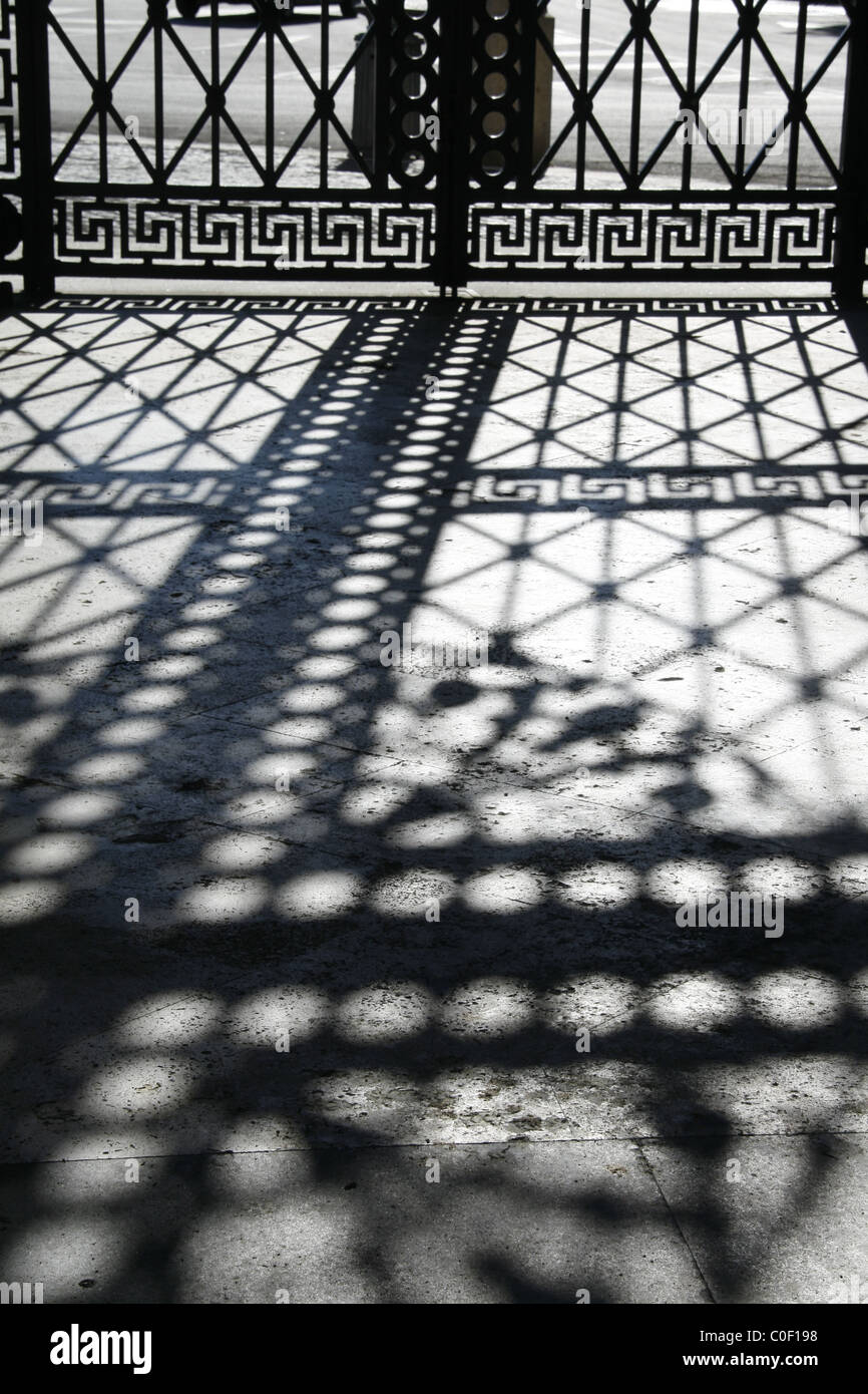 old gate shadow on street road Stock Photo - Alamy