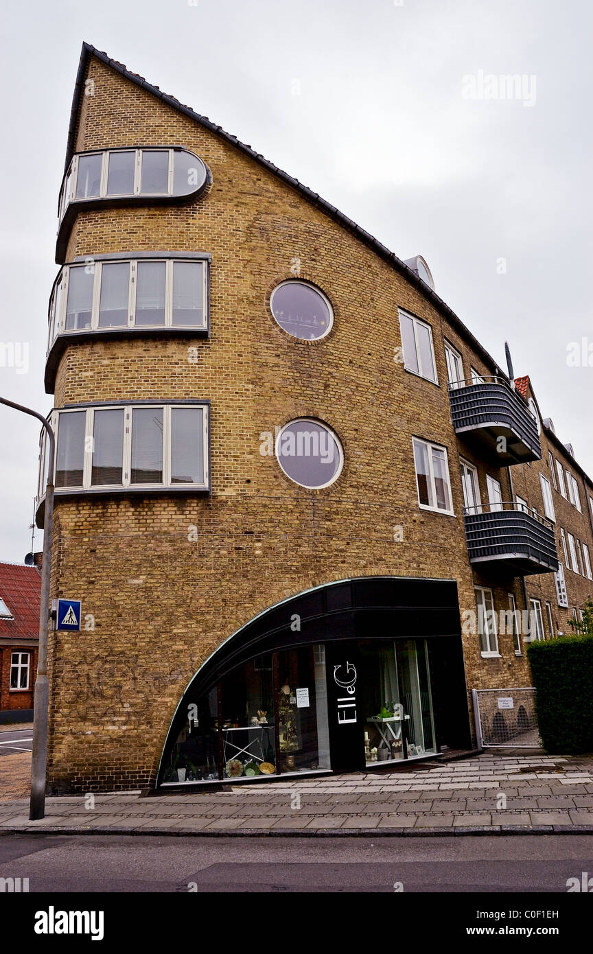 The corner apartments above a local quadrant shaped shop in a block of ...