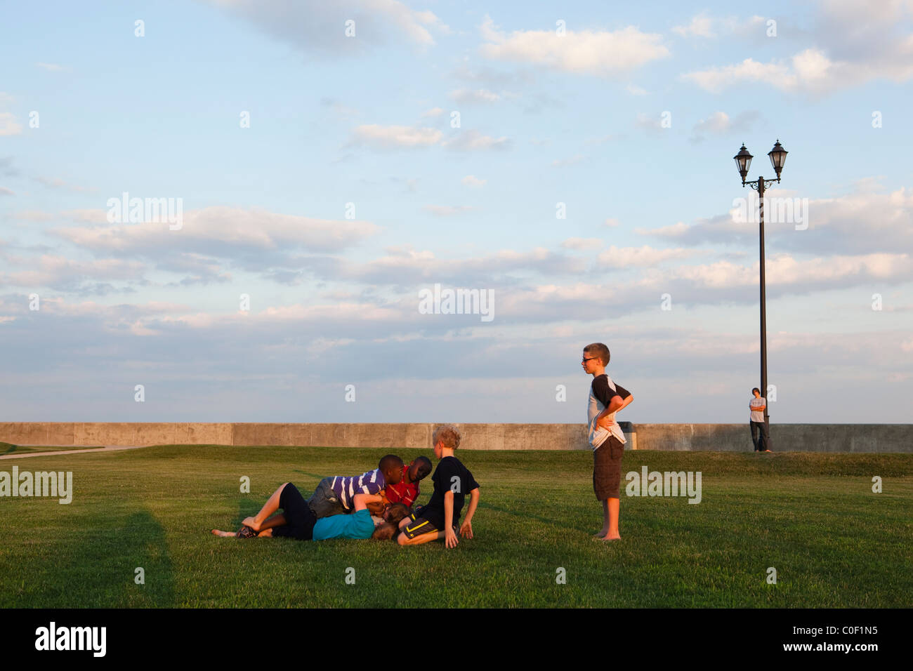 Kids playing on the lawn Stock Photo - Alamy