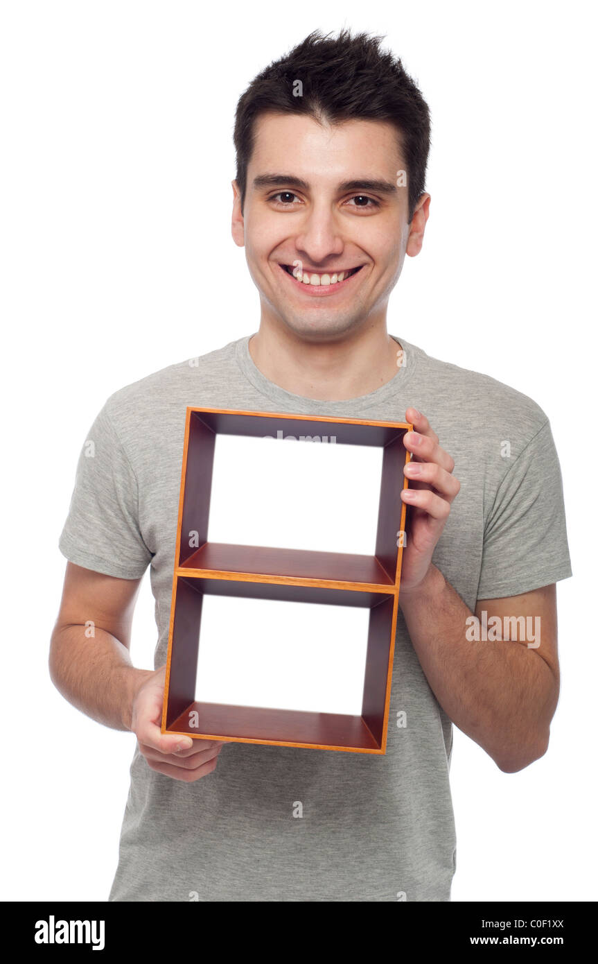 smiling young man holding empty frame isolated on white background ...
