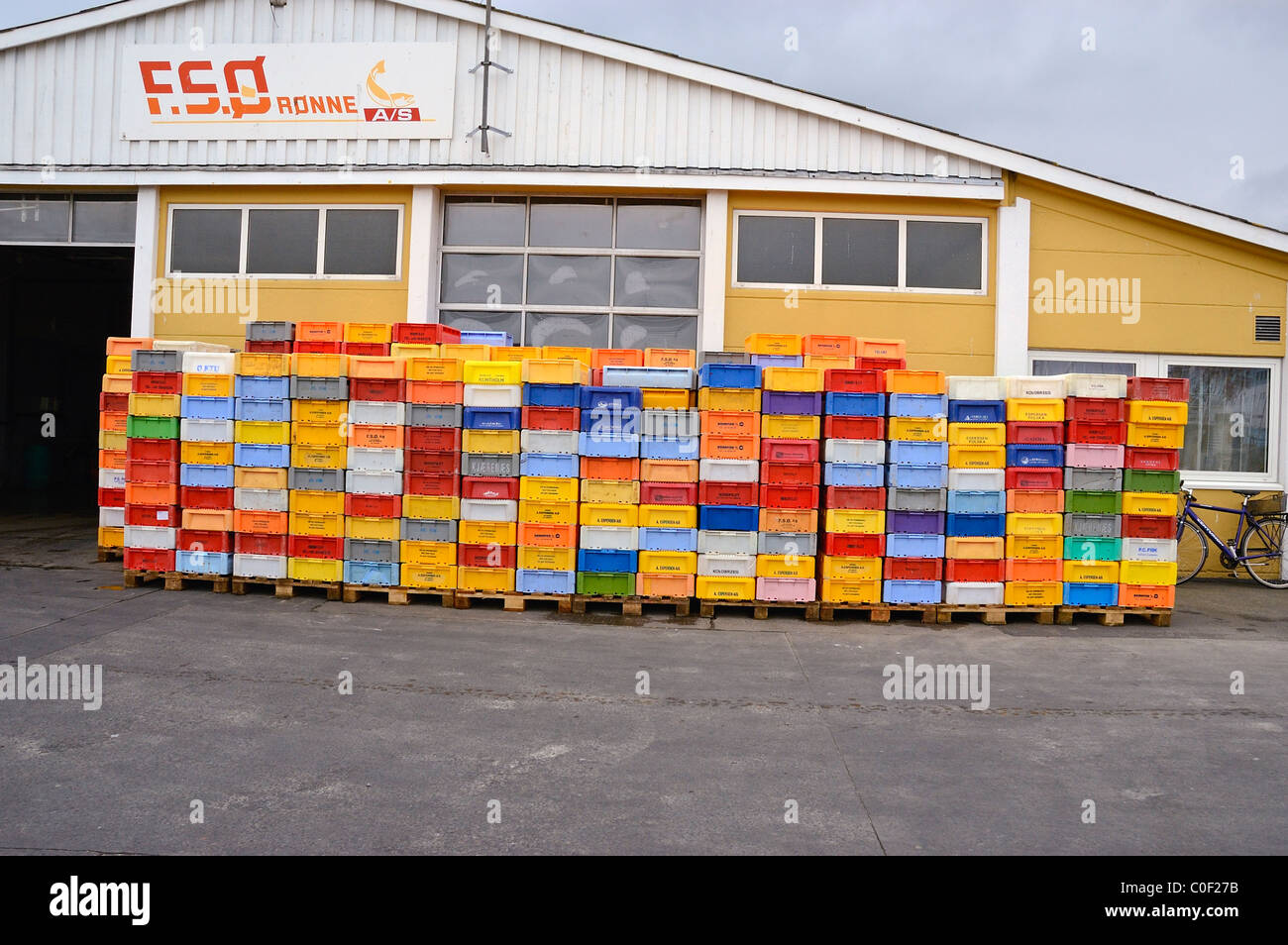Colourful pallets for the transport of fish standing in front of a ...
