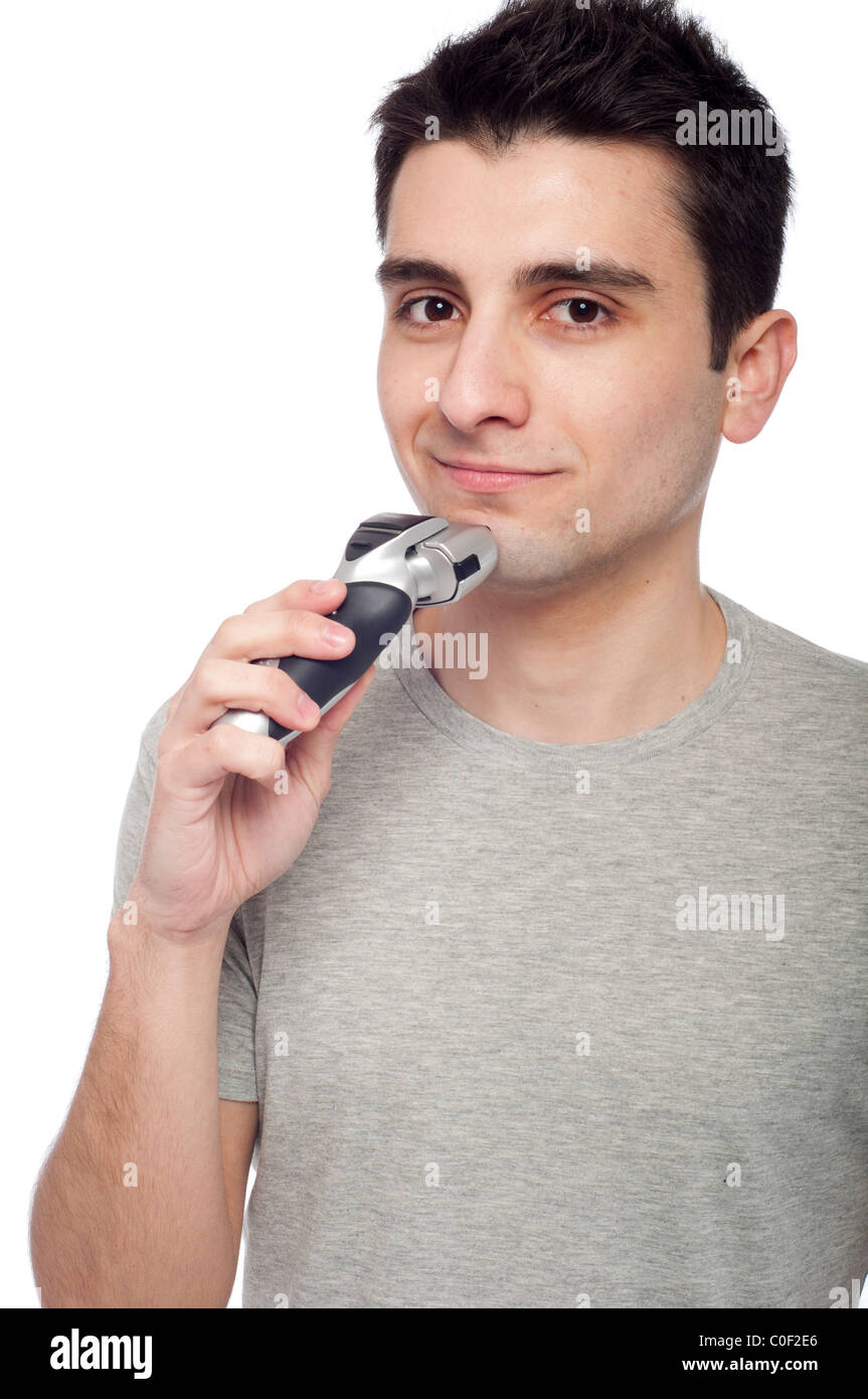 handsome young man shaving with electric shaver (isolated on white ...