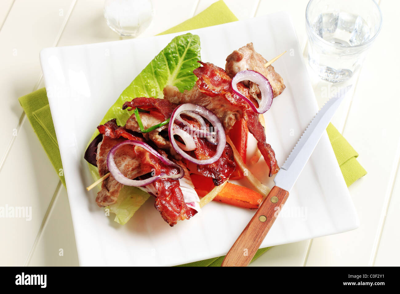 Venison Shish kebab with crispy rashers of bacon and roasted vegetables ...