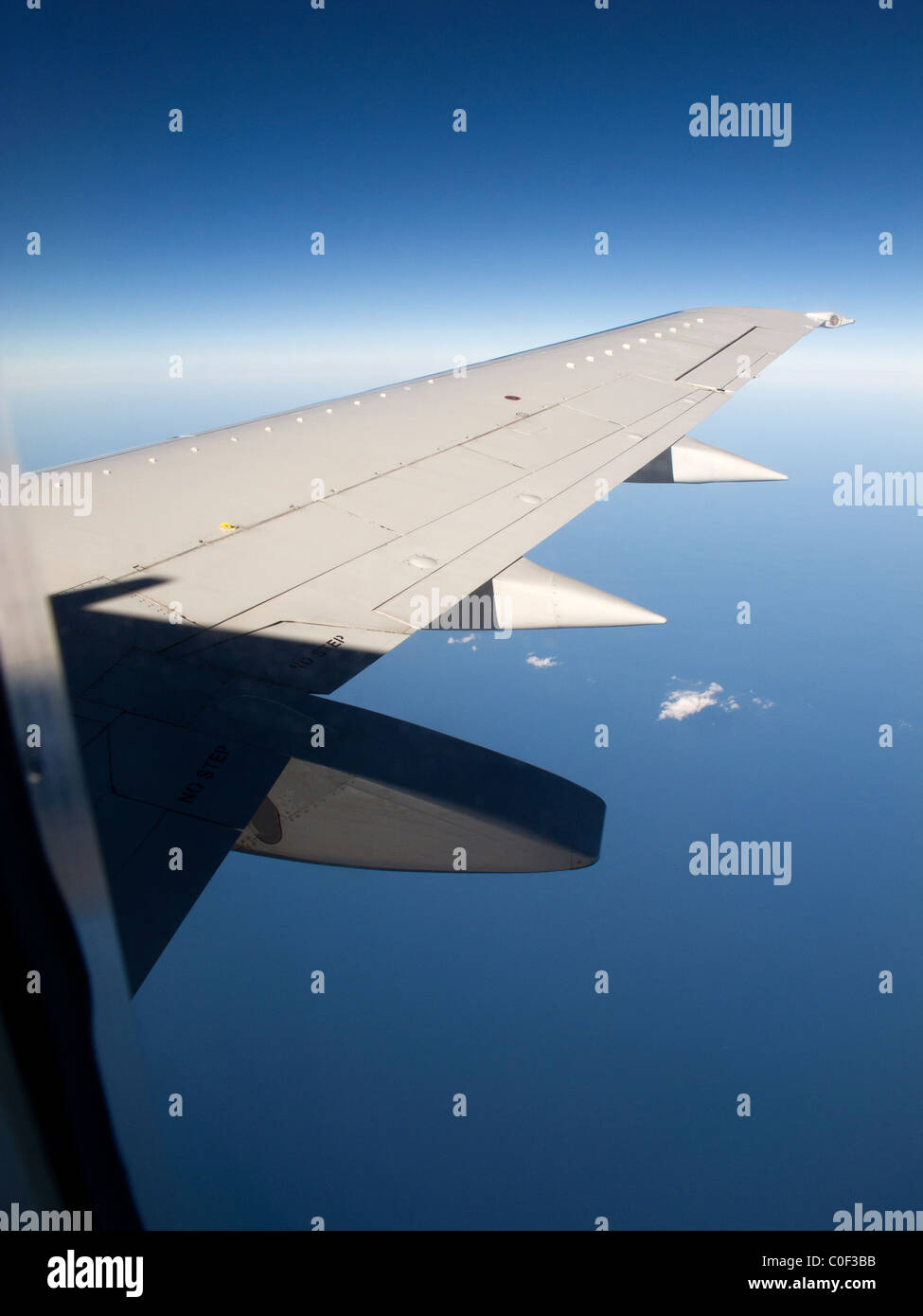 Wing of jet plane over Atlantic ocean Stock Photo - Alamy