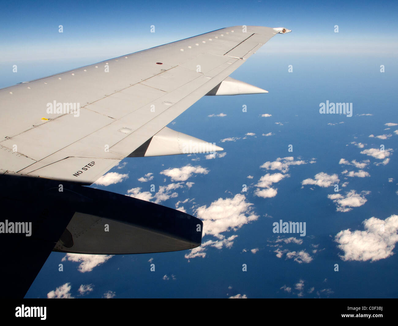 Wing of jet plane over Atlantic ocean Stock Photo - Alamy