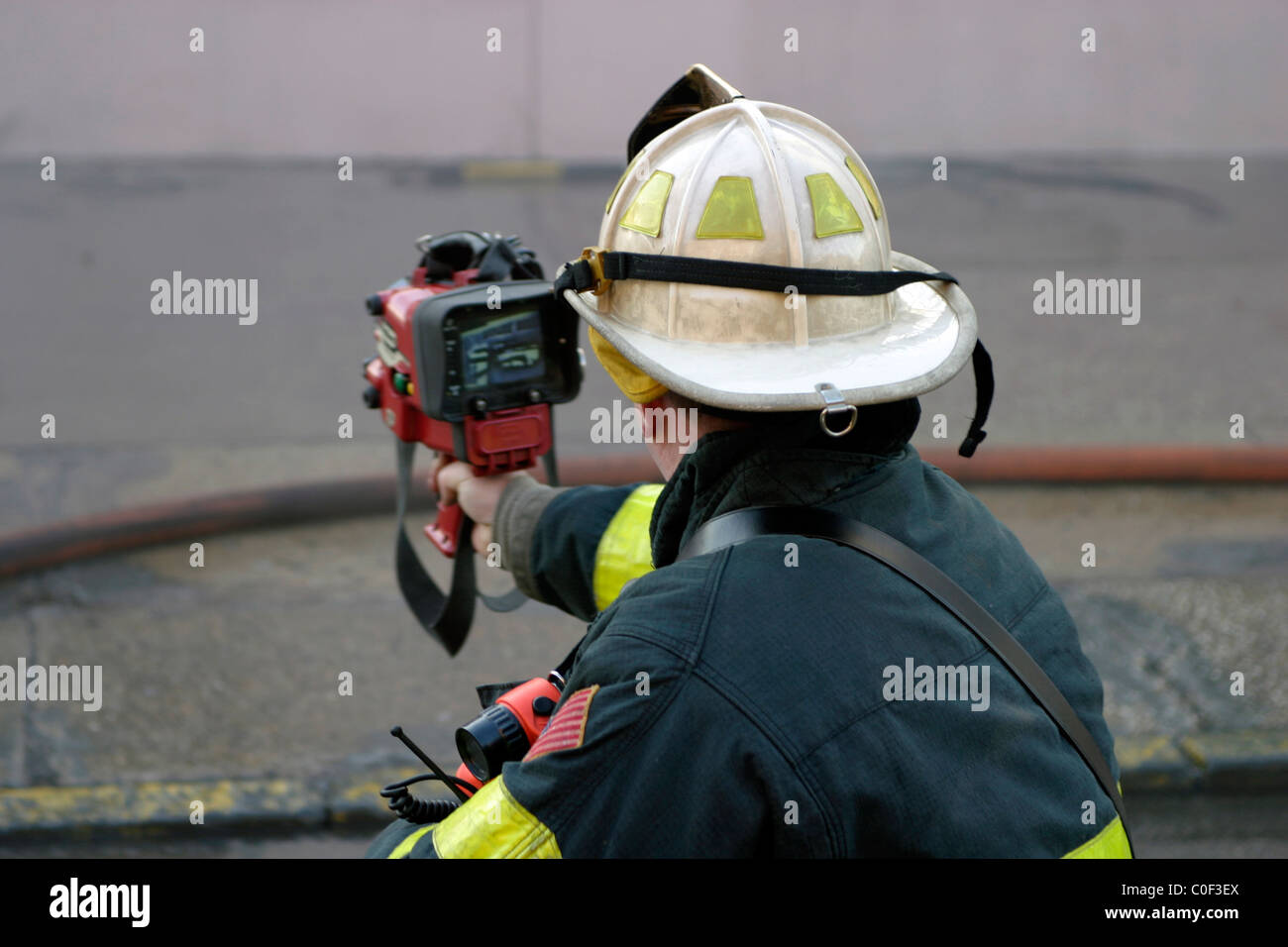 Fireman uses a thermal image camera at scene of a fire Stock Photo - Alamy