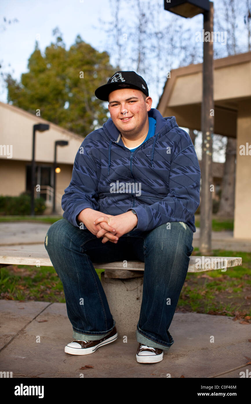Reedley, California, United States. An obese teenager sits for a ...