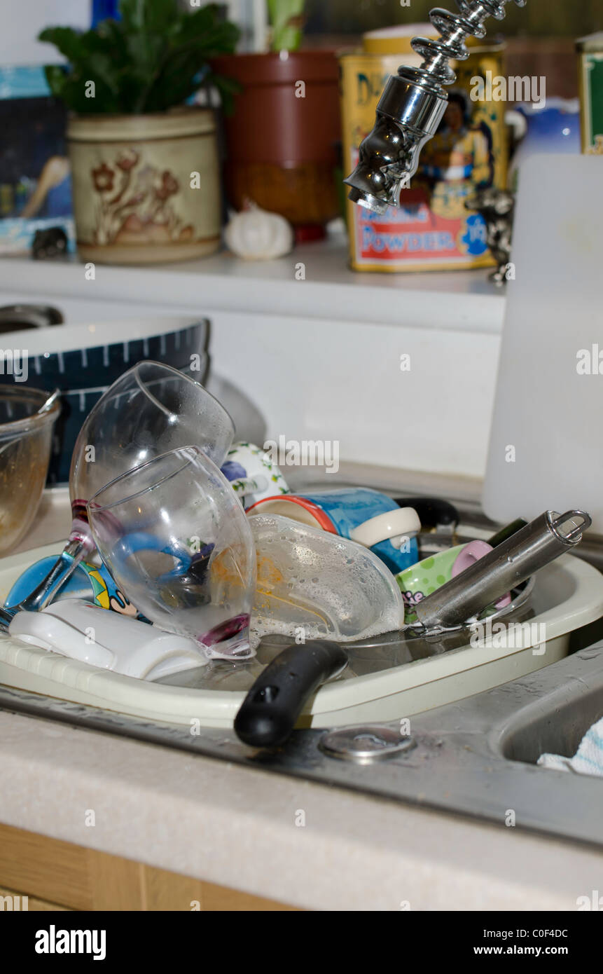 Dirty dishes in a bowl of water Stock Photo - Alamy