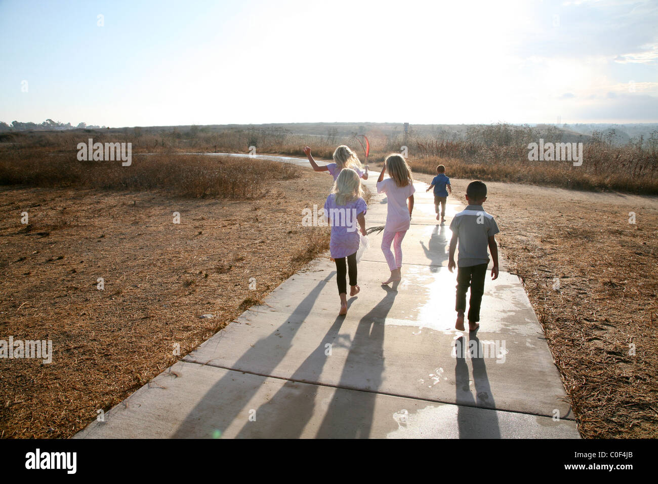 Kids playing on pathway Stock Photo - Alamy