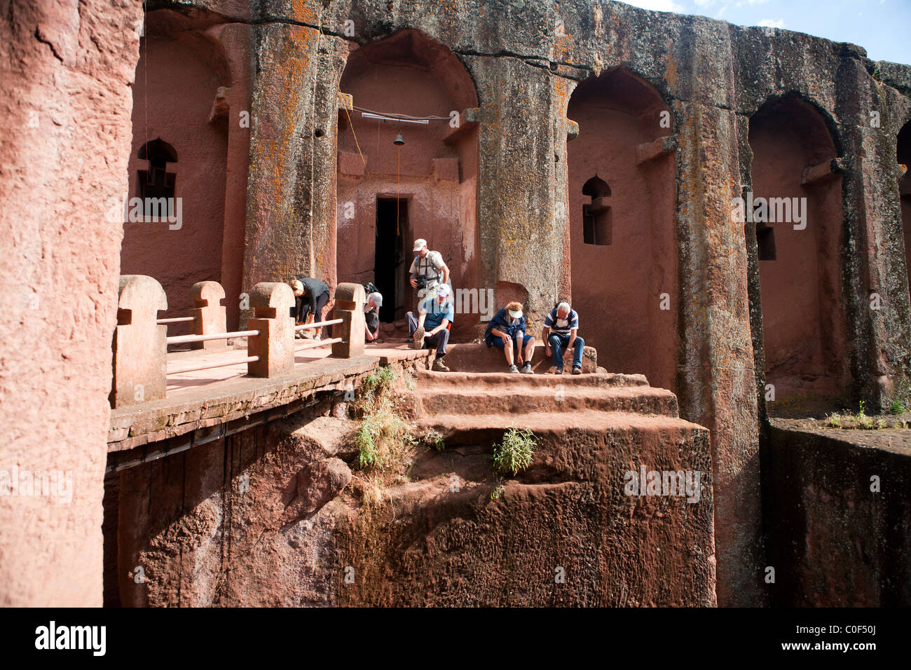 Visitors at the rock-hewn church of Bet Gabriel-Rufael in Lalibela ...