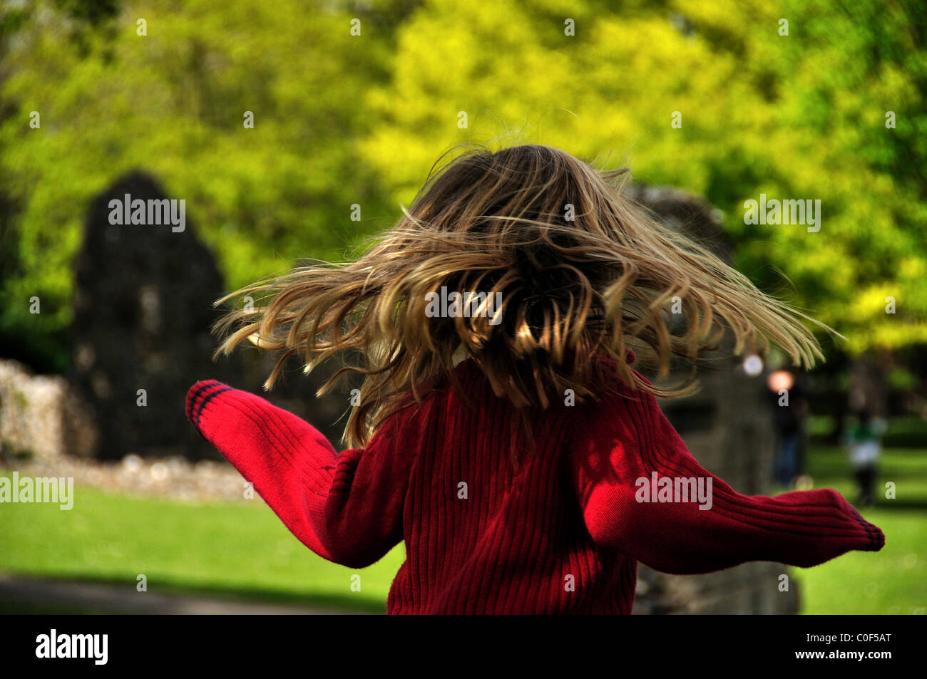 Girl spinning in the park Stock Photo - Alamy