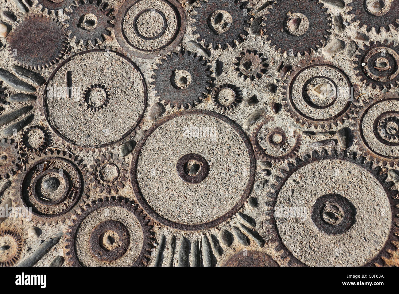 concrete floor with cog-wheels and other technical parts Stock Photo ...