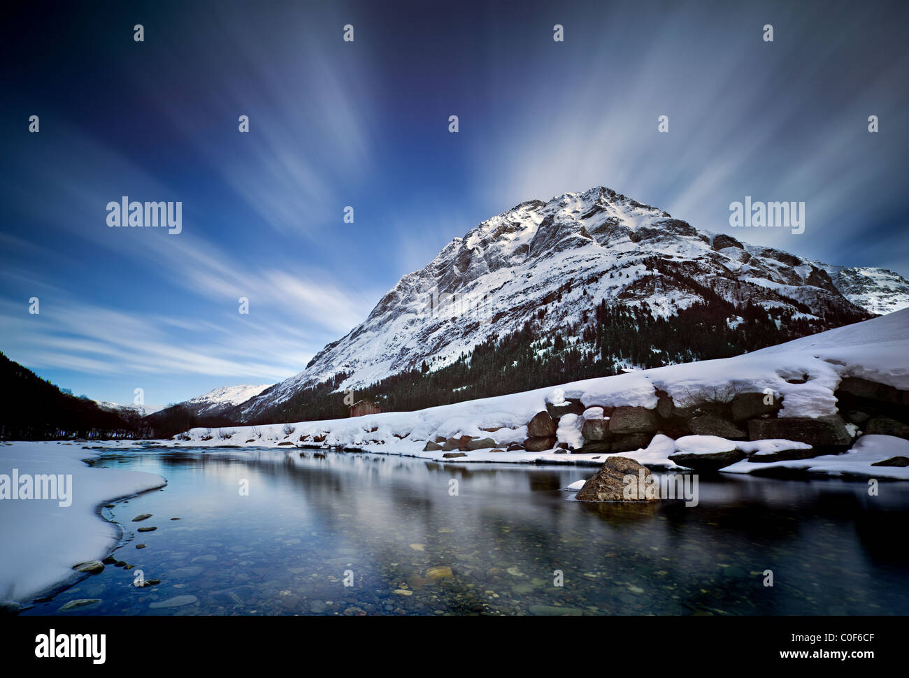 Winter scenery of a mountain reflecting on the river water Stock Photo ...