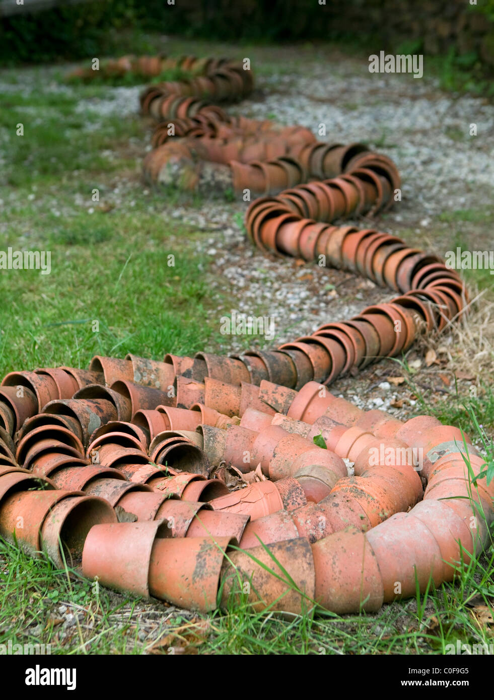 A snakelike sculpture made from flower pots at Pinsla Gardens, Bodmin ...