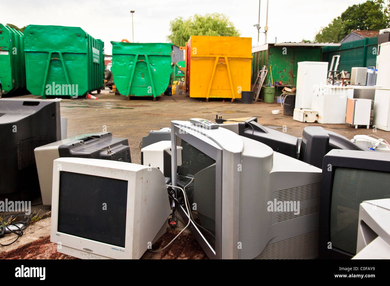 Recycling Televisions with green skips in background Stock Photo - Alamy