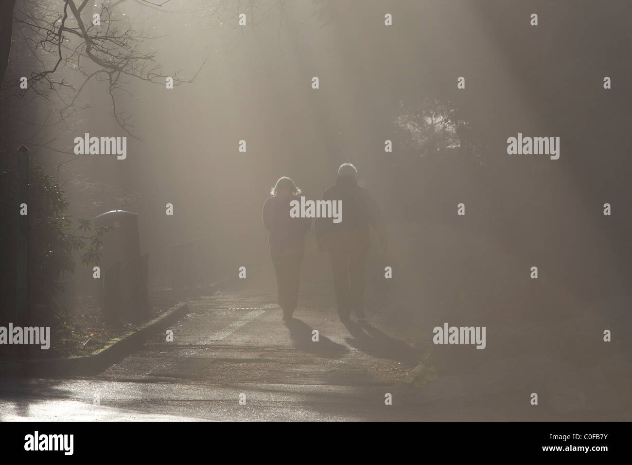 A couple walking in the mist Stock Photo - Alamy
