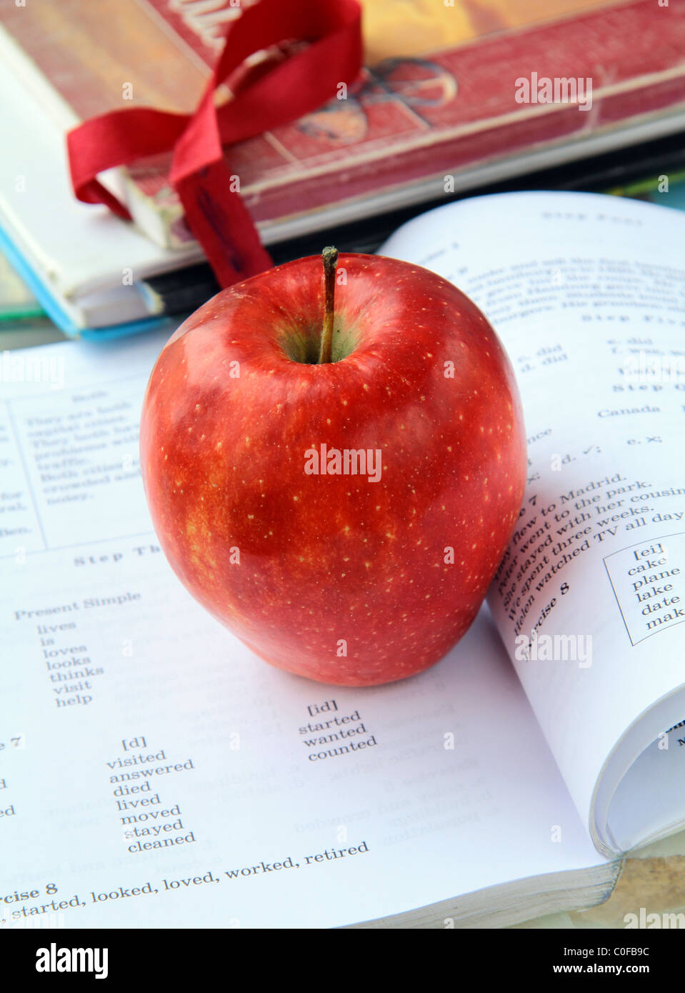 red ripe apple with English textbooks on a black background Stock Photo ...