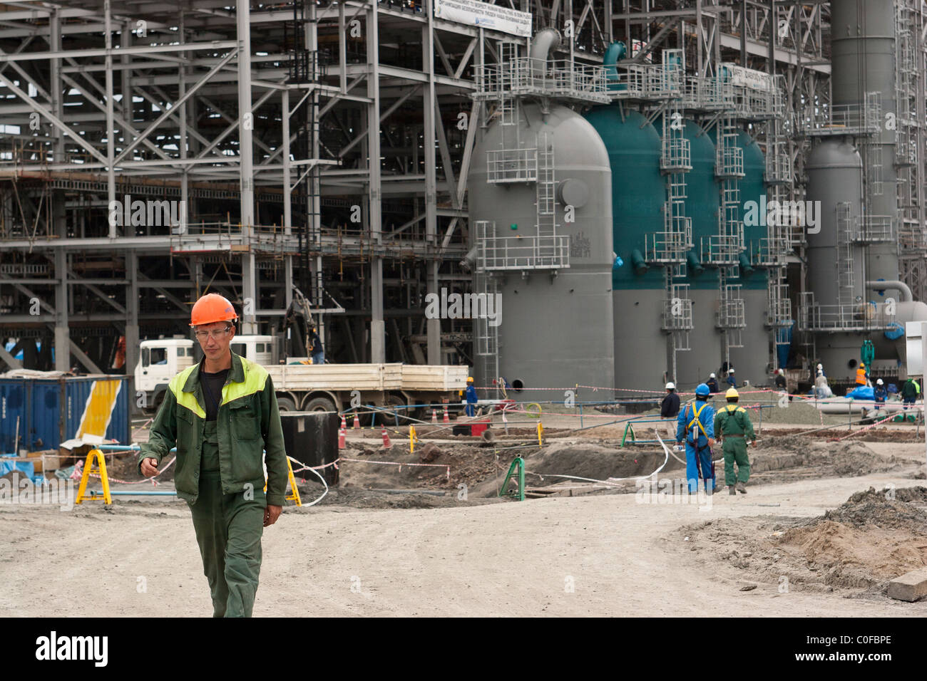 Workmen at work at the Sakenergy liquefied natural gas plant and oil ...
