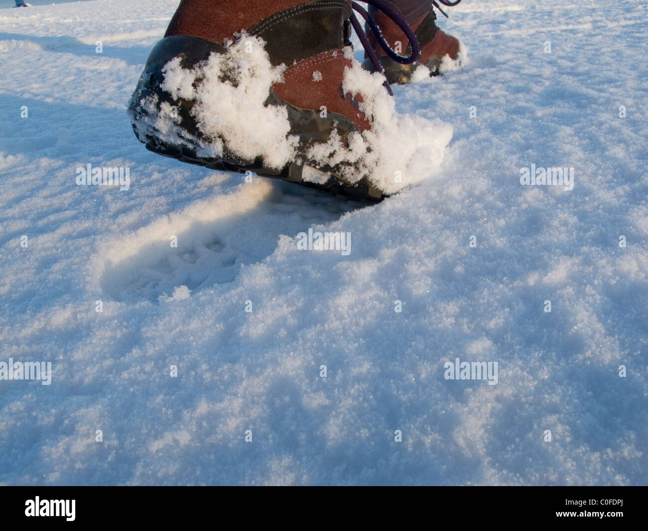 Shoes making Footprints in the snow Stock Photo - Alamy