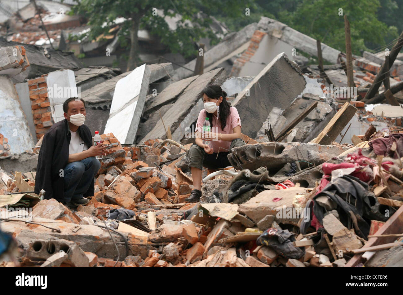 People wait for information on their families following the earthquake ...