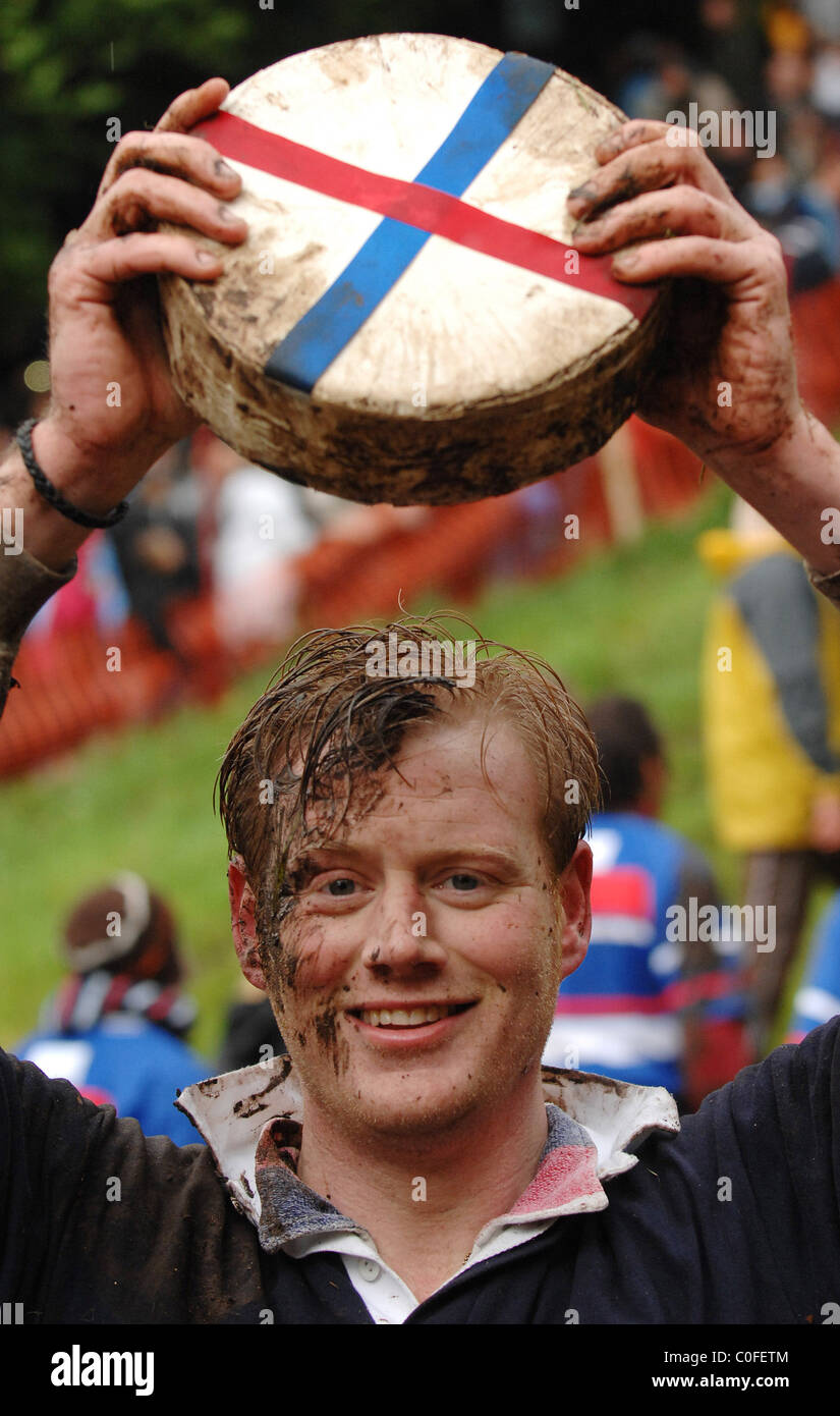 The winner of the men's race Competitors chase a Double Gloucester ...