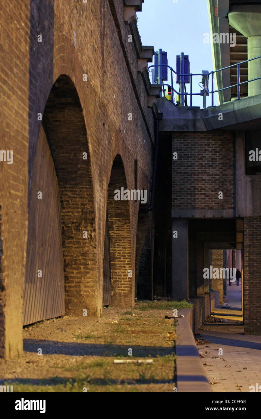 An evening view along railway arches on the Aspen Way by Canary Wharf ...