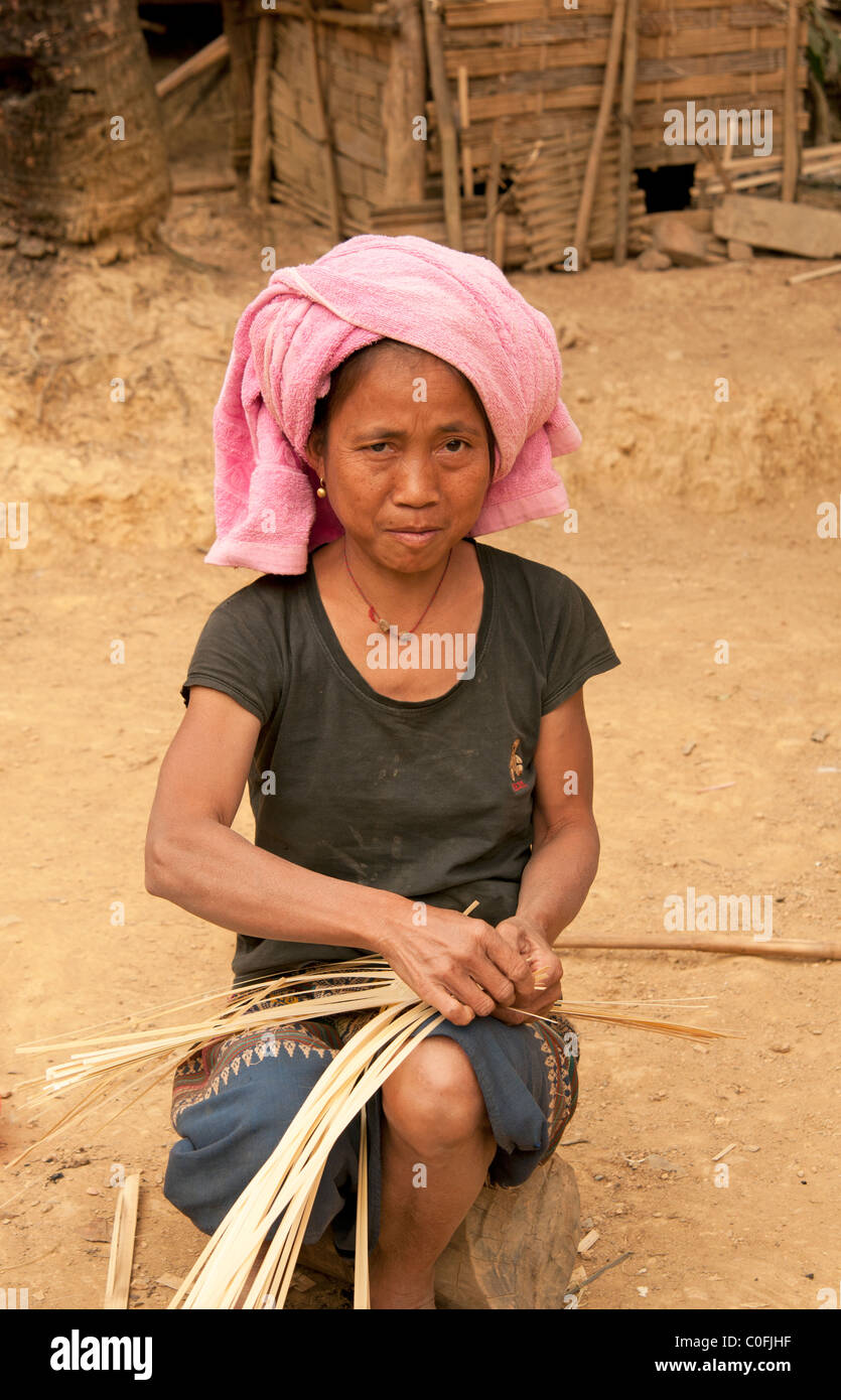 Ethnic tribal woman with rattan work in a village in Northern Laos ...