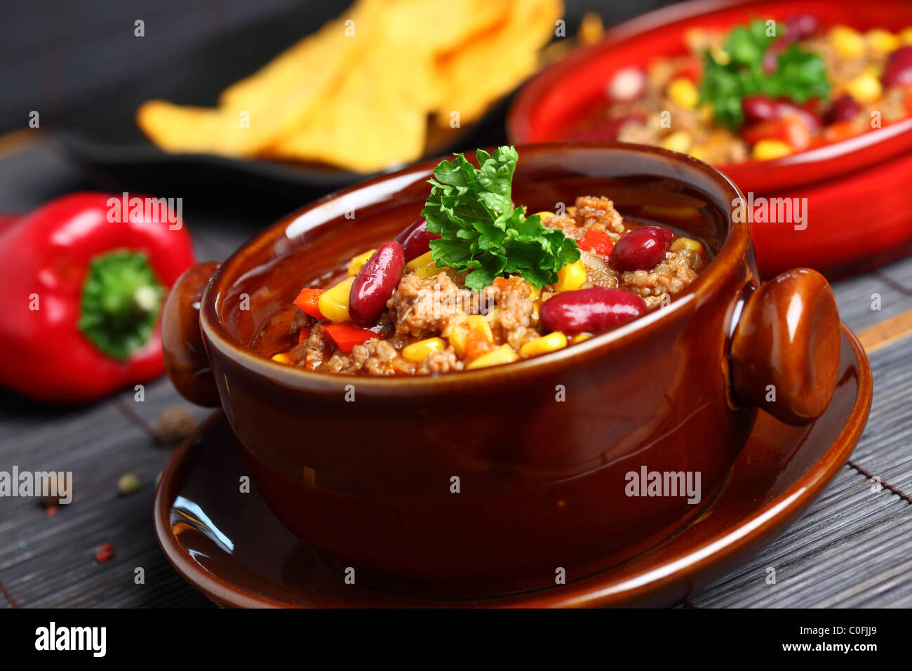 Bowl of chili with peppers and beans Stock Photo - Alamy