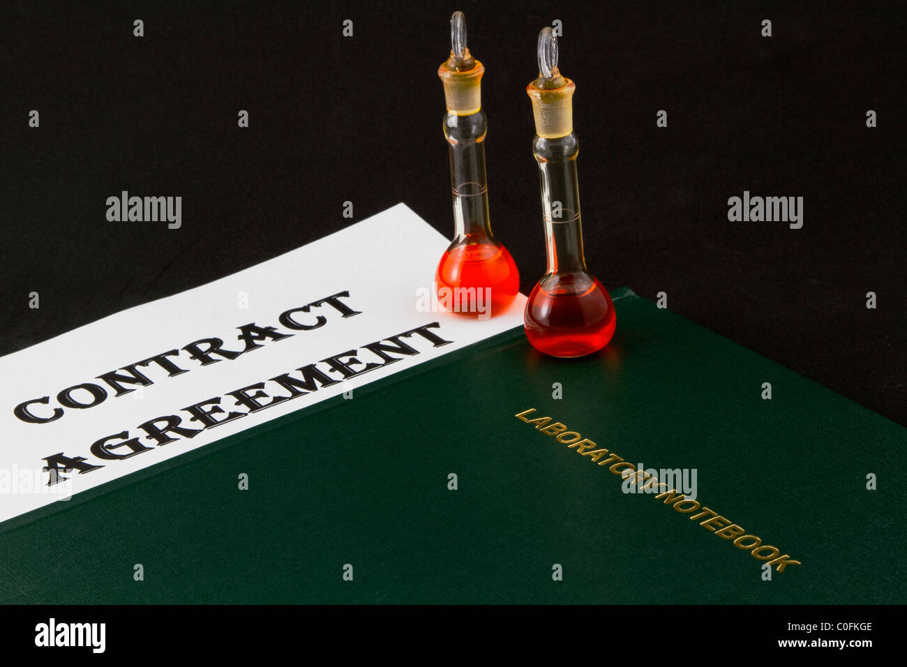 Contract Agreement with two beakers and a laboratory notebook reflects ...