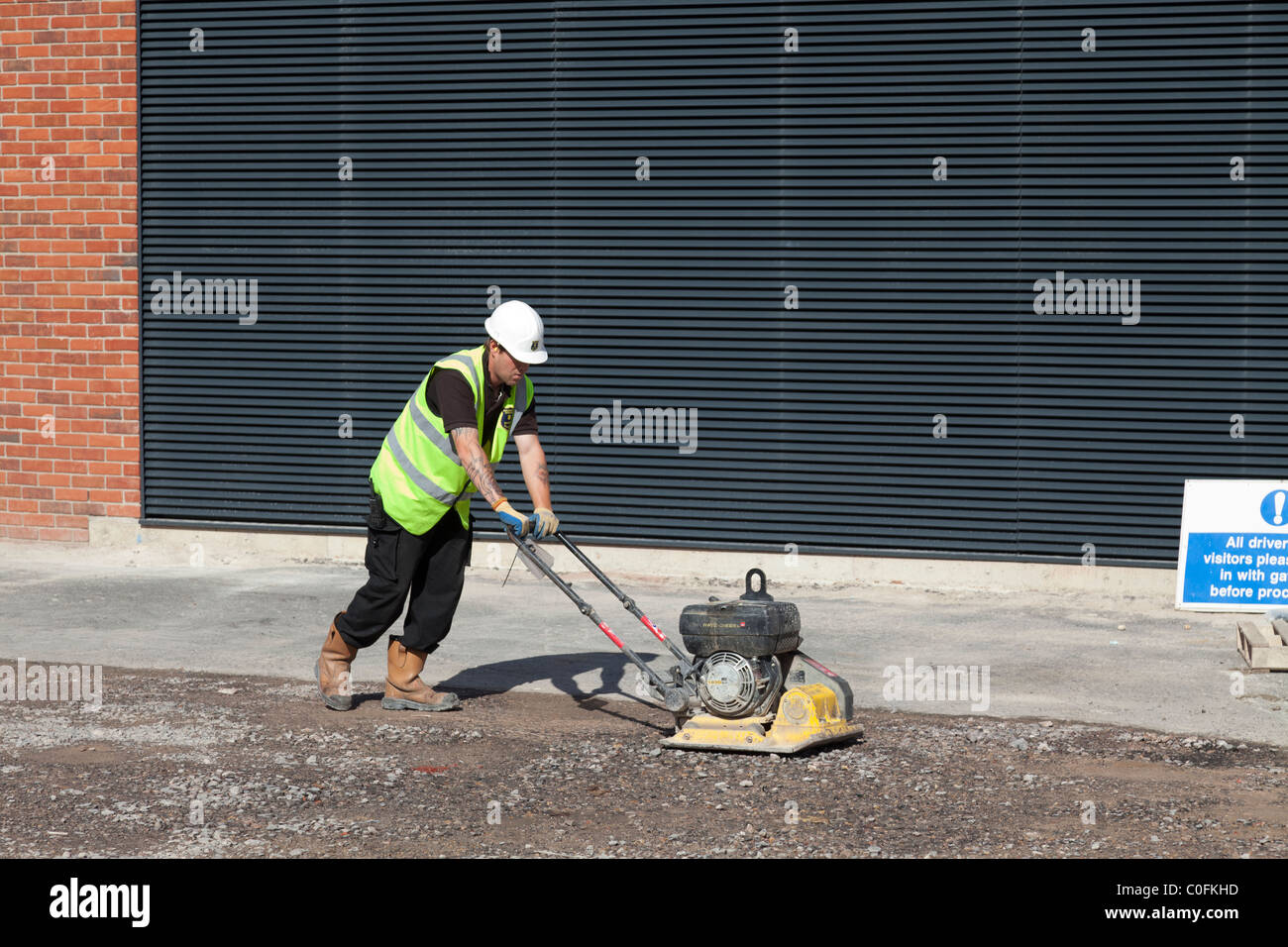construction worker using a compactor Stock Photo - Alamy
