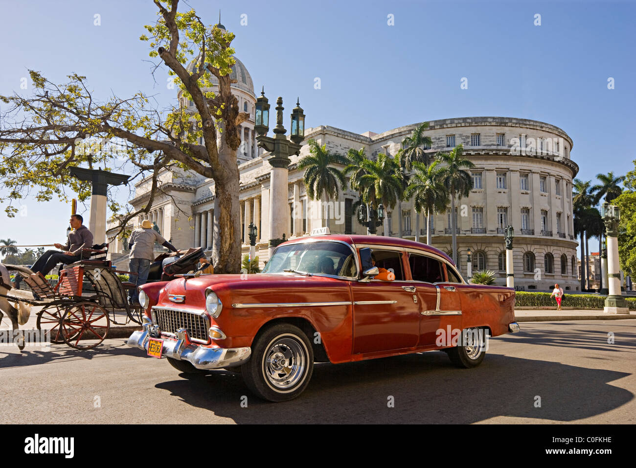 An old American 1950s Chevrolet taxi driving past the Capitol building ...