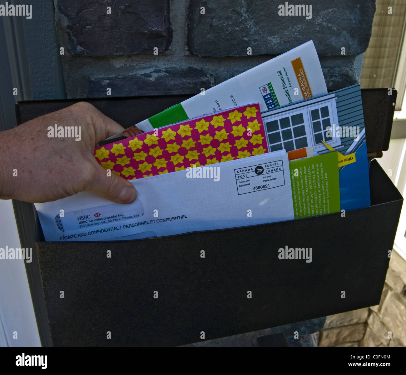 Retrieving mail from the mailbox Stock Photo - Alamy