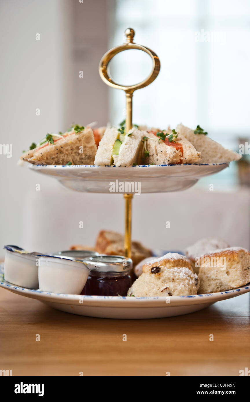 Two-tiered plate of sandwiches and scones in restaurant Stock Photo - Alamy
