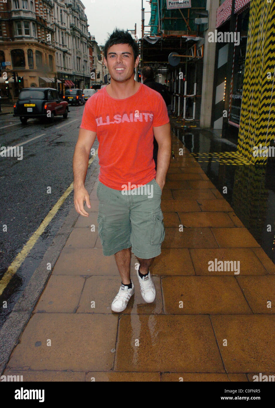 Anthony Hutton strolling down New Bond Street wearing only shorts and a ...