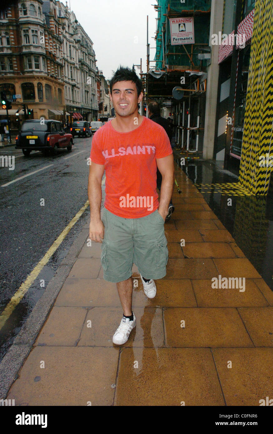 Anthony Hutton strolling down New Bond Street wearing only shorts and a ...