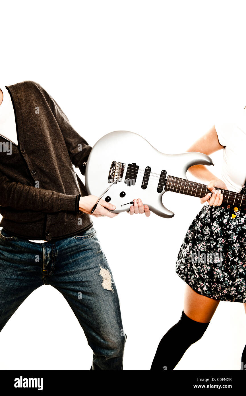 Young girl and guy, fighting over electric guitar Stock Photo - Alamy
