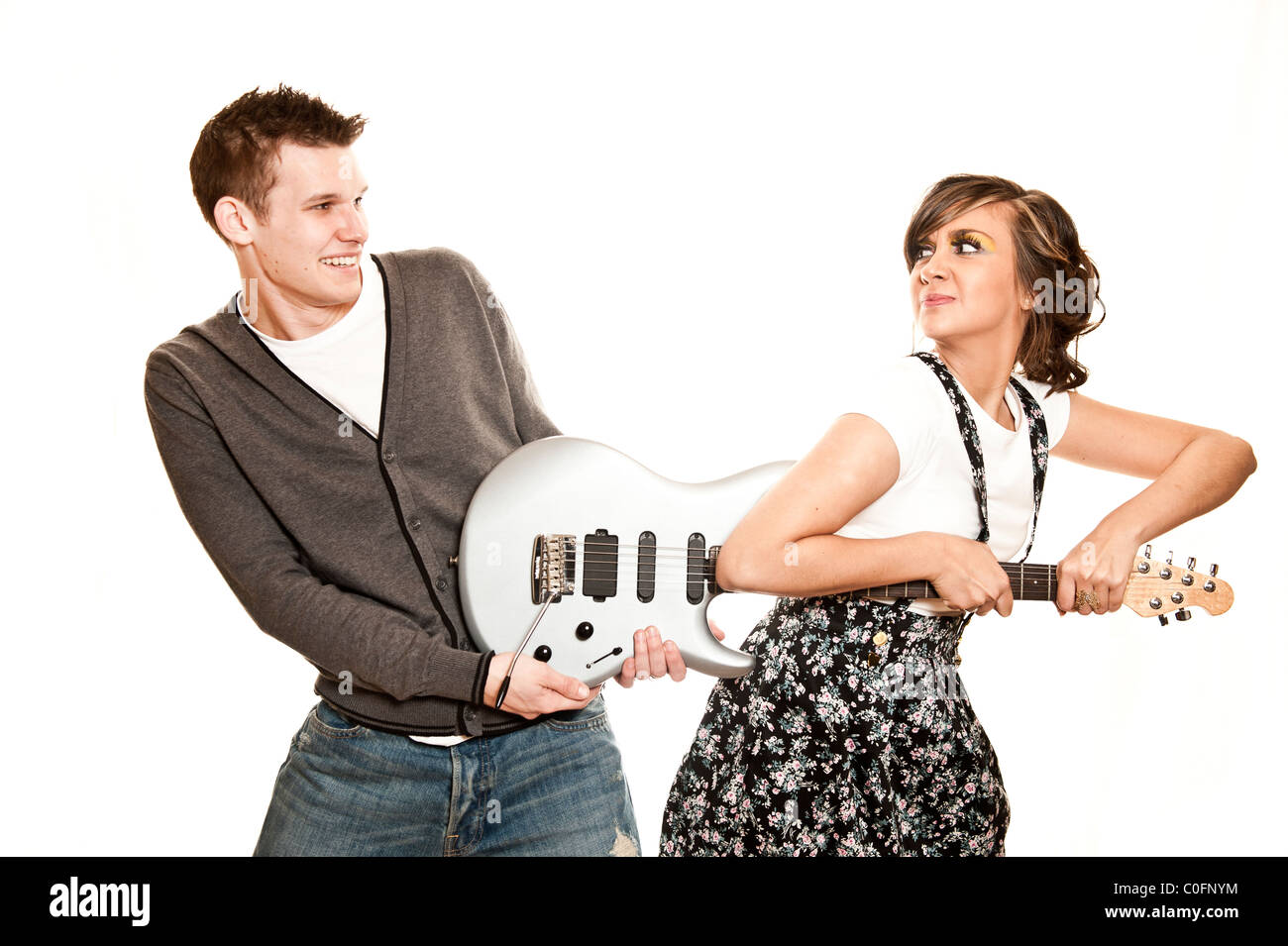 Young girl and guy , fighting over electric guitar Stock Photo - Alamy