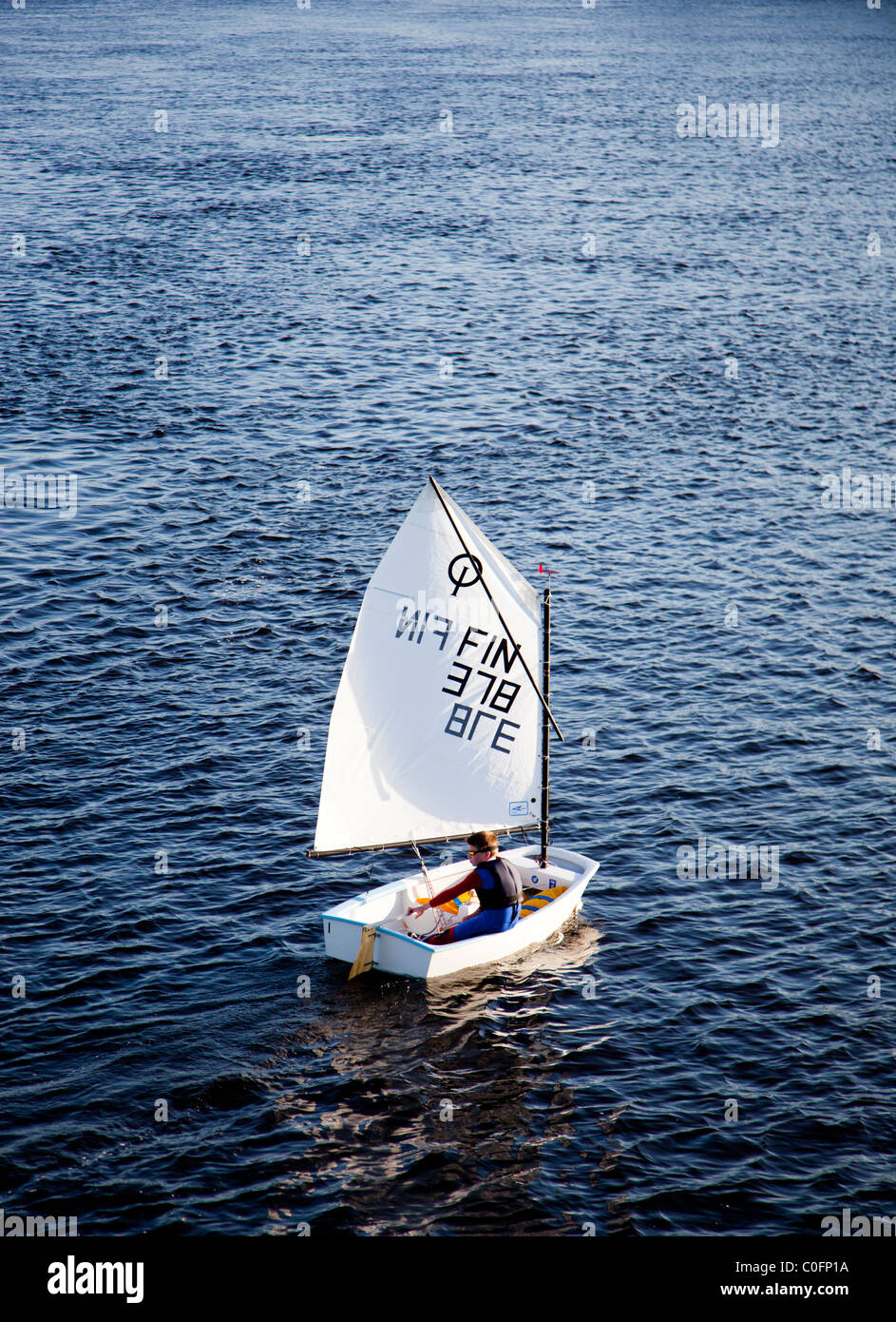 Young boy sailing alone with a small sailing boat , Finland Stock Photo ...