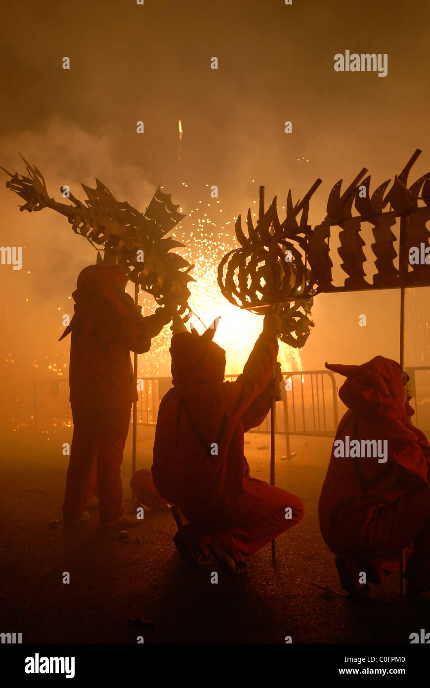 Fireworks going off over Falleros wearing red devil costume during ...