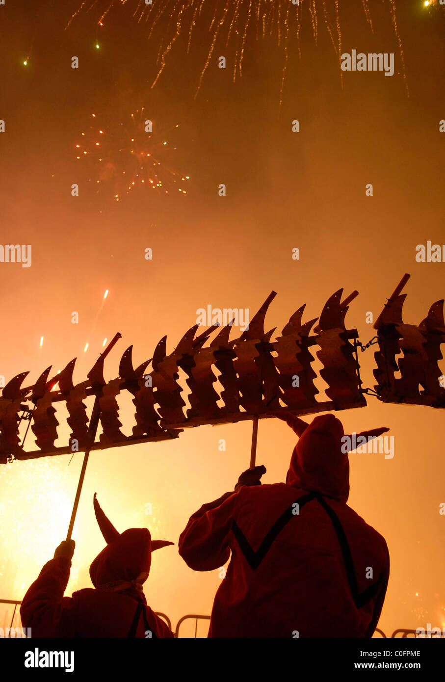 Fireworks going off over Falleros wearing red devil costume during ...