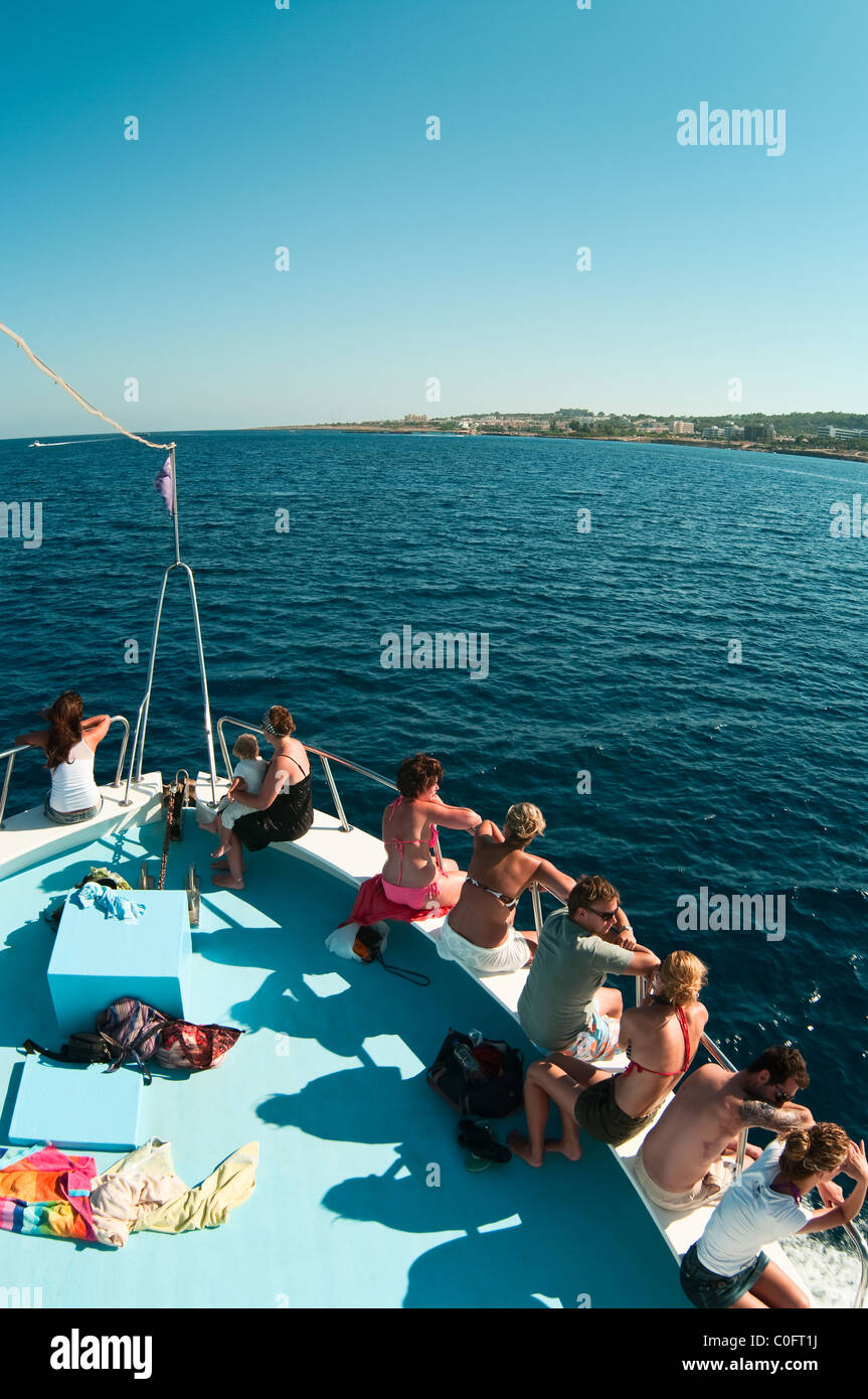 Boat trip across the Mediterranean Sea, Cyprus shore. Several people ...