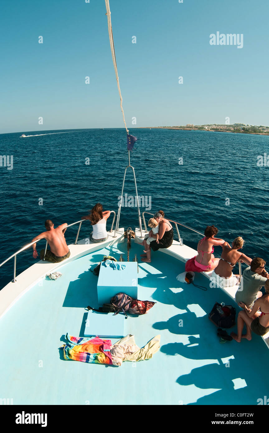 Boat trip across the Mediterranean Sea, Cyprus shore. Several people ...