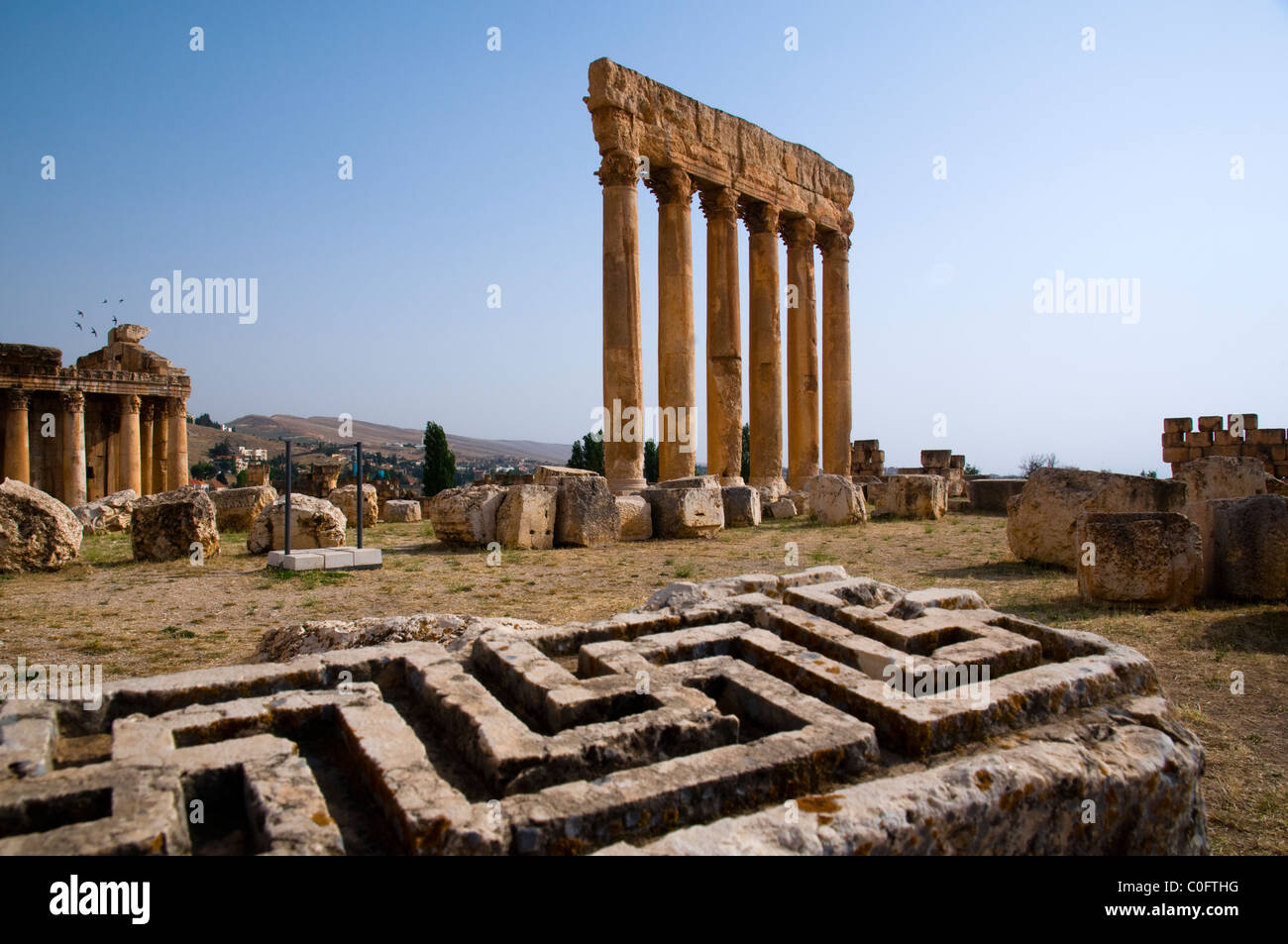 Swastika cross carved in a stone and the Temple of Jupiter, Baalbek ...