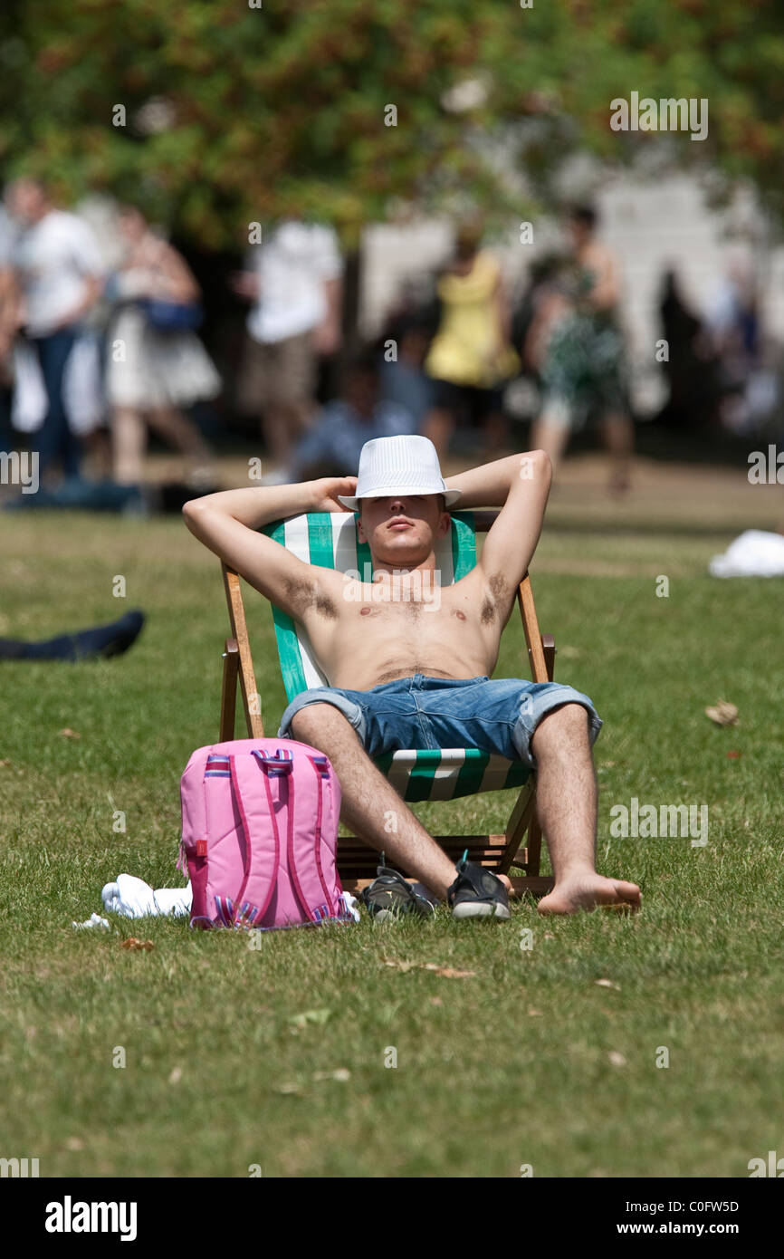 man in sun hat enjoying the sun in St James's Park, London, England, UK ...